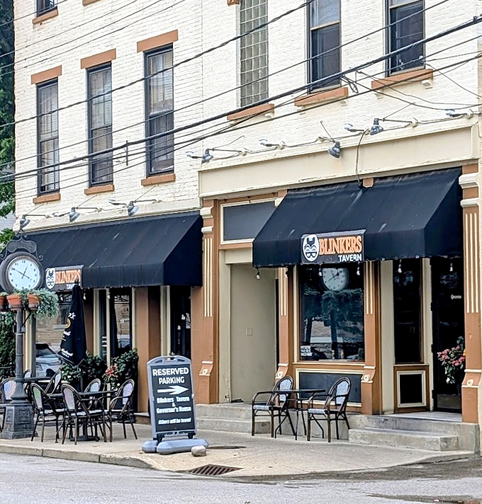 The distinctive black awnings and classic clock make Blinkers an unmistakable landmark in Covington's charming streetscape.