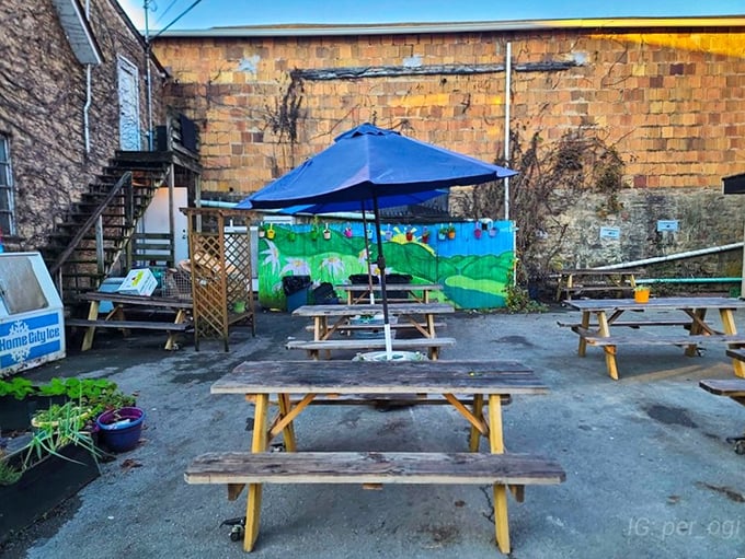 The back patio &ndash; where picnic tables and a hand-painted mural create an outdoor oasis for those who prefer their coffee with a side of fresh air. 