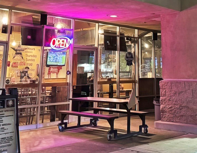 Outdoor seating bathed in the glow of neon, perfect for those "too full to move but want one more bite" moments.