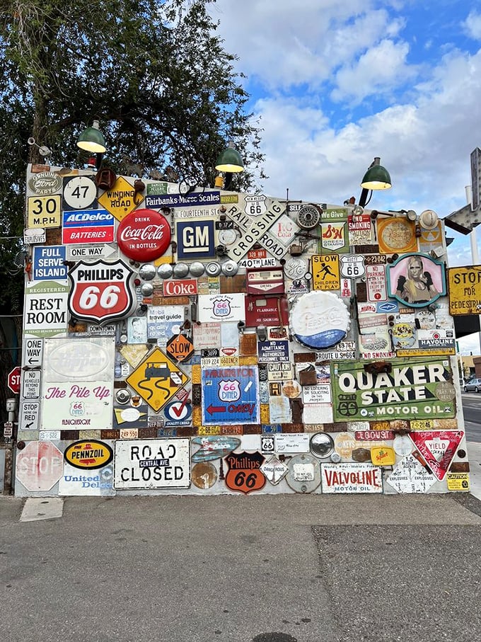 This wall of vintage signs isn't just decoration&mdash;it's a roadside museum where every rusted emblem tells a story of American highways.