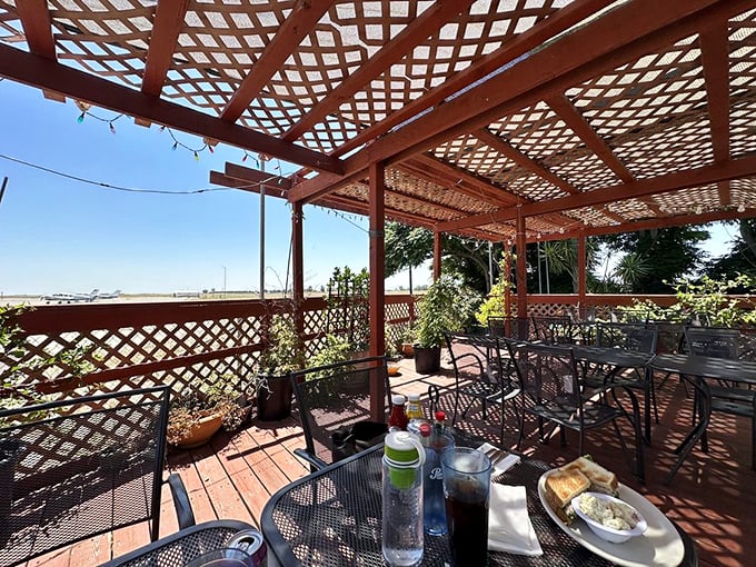 The outdoor patio where planes occasionally provide the entertainment and the breeze carries hints of what's cooking inside. California dining at its most honest.