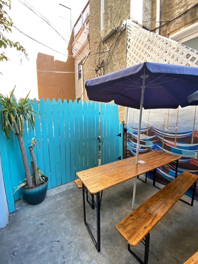 The hidden backyard oasis with its bright blue fence offers a peaceful retreat from South Street's hustle. Sandwich nirvana found in unexpected places.