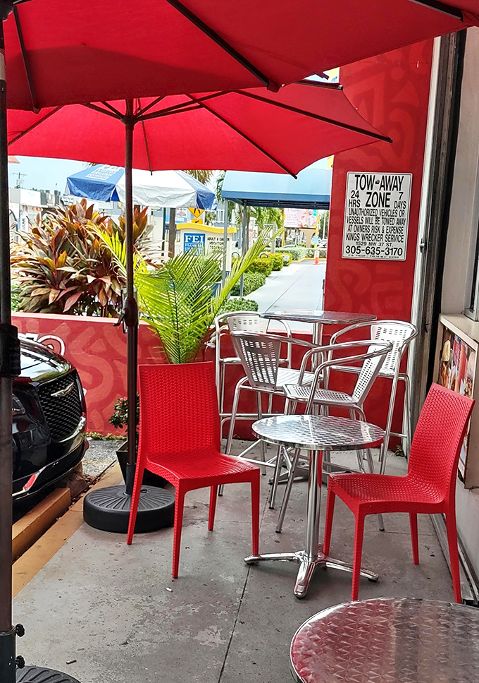 A splash of outdoor seating where Miami's tropical breeze complements your meal. Red umbrellas: practical shade or flavor enhancers? Both.
