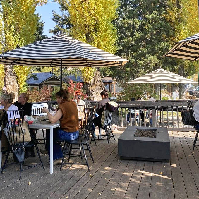 Autumn magic on the deck, where striped umbrellas shade happy diners enjoying their treats against a backdrop of golden aspen leaves. Mountain dining at its finest.
