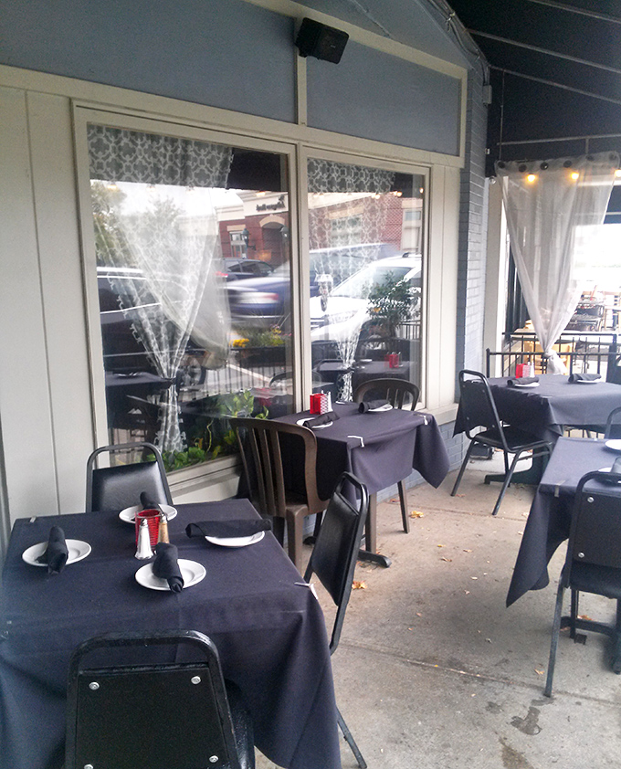 Outdoor tables dressed in tablecloths suggest alfresco dining done right, weather gods willing to cooperate today.