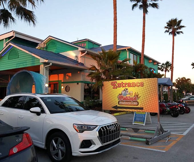The parking lot at dusk hints at the colorful experience waiting inside&mdash;palm trees included at no extra charge.