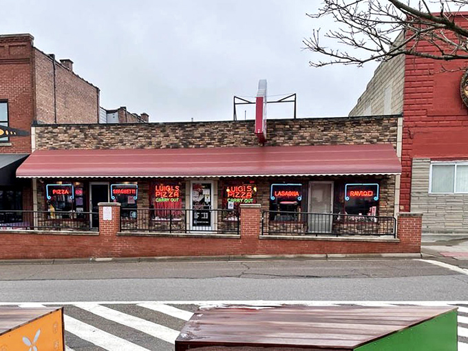 Luigi's storefront, with its row of neon signs, stands as a testament to the enduring appeal of no-nonsense Italian-American cuisine.