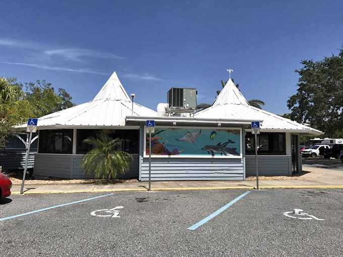 The distinctive white peaks of Dixie Crossroads' roof &ndash; a seafood cathedral under the Florida sky.