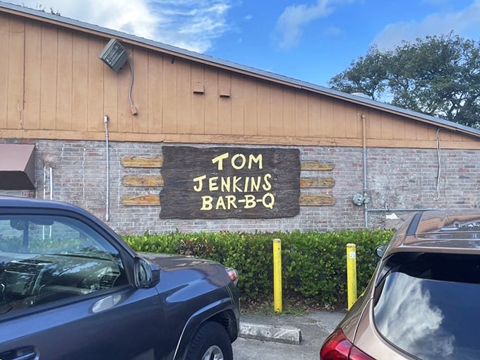The parking lot view that signals you've arrived at the promised land. Cars from all walks of life united by the pursuit of perfect barbecue.