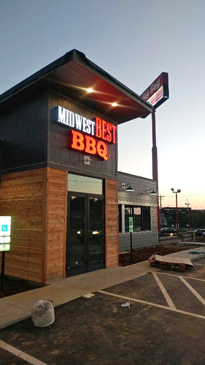 As day turns to dusk, the Midwest Best BBQ sign glows like a lighthouse, guiding hungry travelers to smoky salvation. 