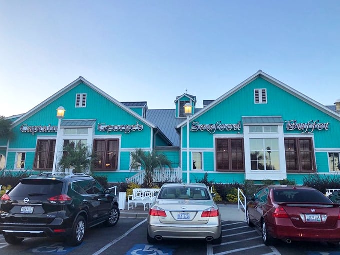 Captain George's exterior announces itself with unmistakable coastal charm—a turquoise landmark that's become the North Star for seafood pilgrims along the Grand Strand.