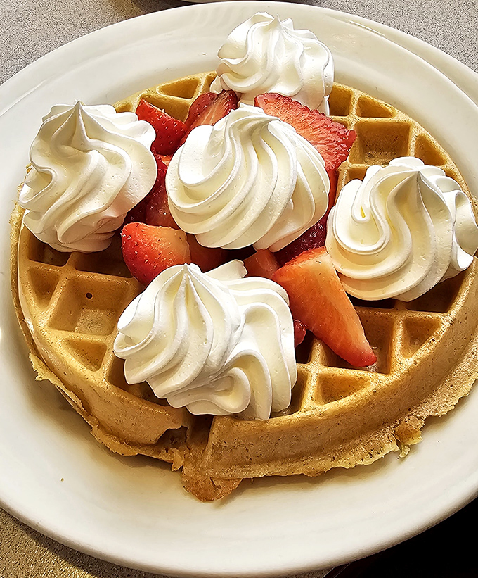 A waffle that doesn't just hold strawberries and cream&mdash;it cradles them like precious jewels on a golden throne.