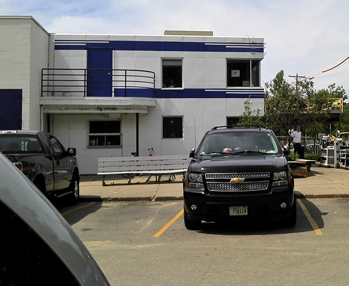 Even the parking lot maintains the blue and white color scheme. The diner's Art Deco-inspired architecture stands as a beacon for hungry travelers.