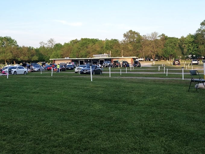 The grounds await the evening crowd, a temporary neighborhood that forms around shared stories on screen.