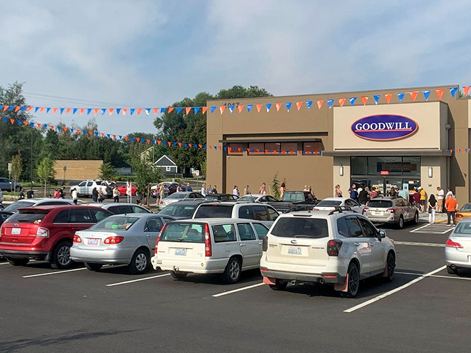A bustling parking lot under blue skies reveals the true popularity of this treasure-hunting ground – Goodwill as community gathering place.