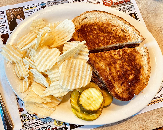 The patty melt—that perfect marriage of grilled sandwich and burger—flanked by ridged potato chips and pickles. A lunch that understands you.
