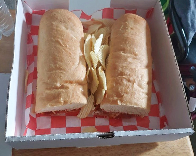 The pizza sub arrives like a diplomatic compromise between two beloved foods, nestled in a box that practically whispers, "You made the right choice today."