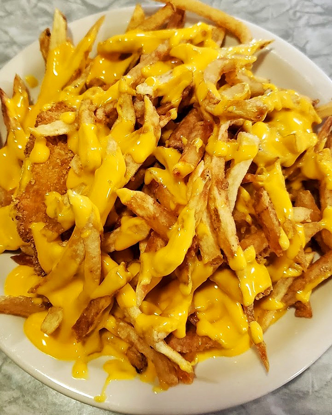 Cheese fries that understand the meaning of commitment &ndash; no half-measures here, just full cheese coverage that would make an insurance agent proud.