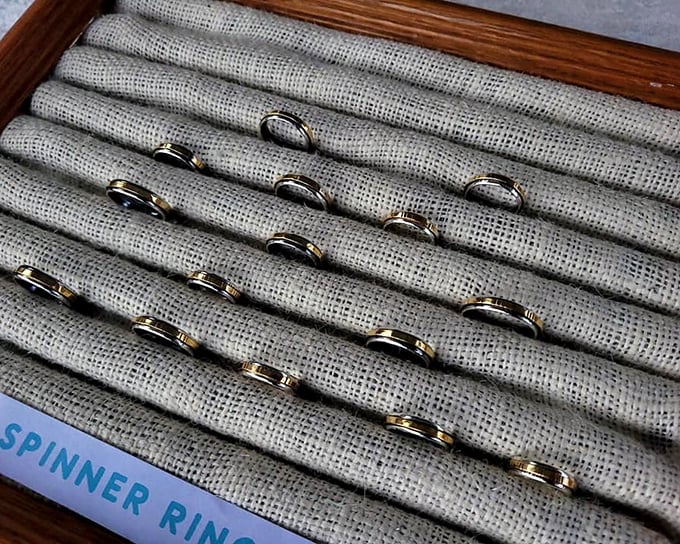 Spinner rings lined up like tiny worry-tamers, ready to adorn fidgety fingers with a touch of handcrafted calm.