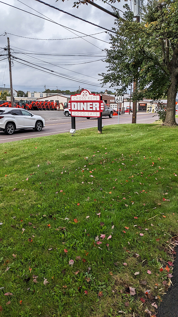 The roadside sign stands like a breakfast lighthouse, guiding hungry travelers to a port of pancakes and coffee.