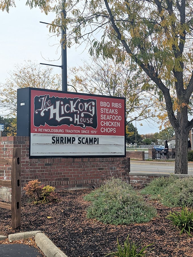 The roadside sign stands as a beacon for hungry travelers&mdash;BBQ, steaks, seafood, chicken, and chops all under one hickory-scented roof.