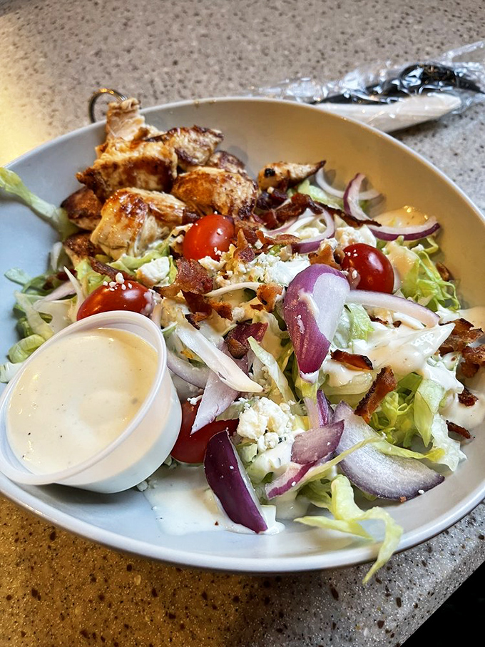 Even the salads at a burger joint deserve respect. This bowl of freshness offers a strategic balance to your indulgent main mission.