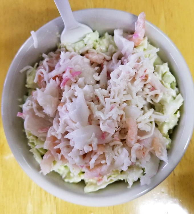 This isn't just coleslaw&mdash;it's a fresh, crisp counterpoint to fried delights, studded with seafood treasures that elevate it from side to essential.