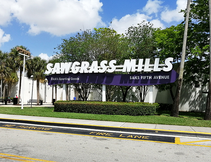 The roadside sign: Florida's version of "Abandon hope all ye who enter"—but in a good way that involves designer discounts and food court rewards.