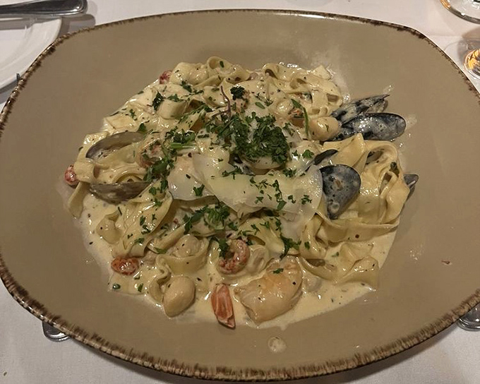 This seafood pasta isn't just dinner&mdash;it's a delicate dance of shellfish and noodles performing in perfect harmony on a cream-sauce stage.