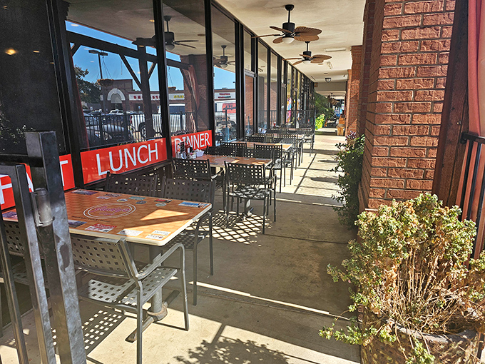 The outdoor seating area offers a front-row view of strip mall life &ndash; somehow transformed into a charming sidewalk cafe experience through the magic of good food.