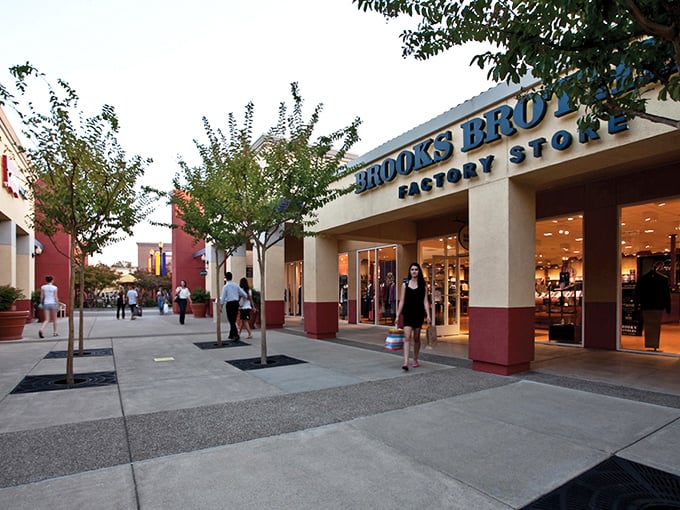 Brooks Brothers beckons with promises of preppy perfection at palatable prices. The evening light casts a golden glow on potential wardrobe upgrades.