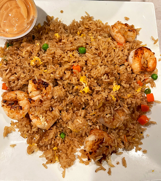 Shrimp fried rice that strikes the perfect balance between comfort food and seafood indulgence. Each grain tells a story of perfect seasoning.