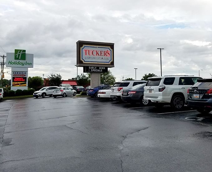 The roadside sign stands as a landmark for locals who measure directions by saying, "It's just past Tucker's on the right."
