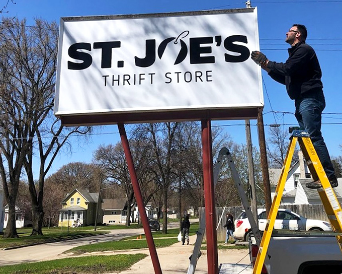 St. Joe's sign getting a refresh &ndash; because even thrift store signage deserves a second chance at making a first impression.