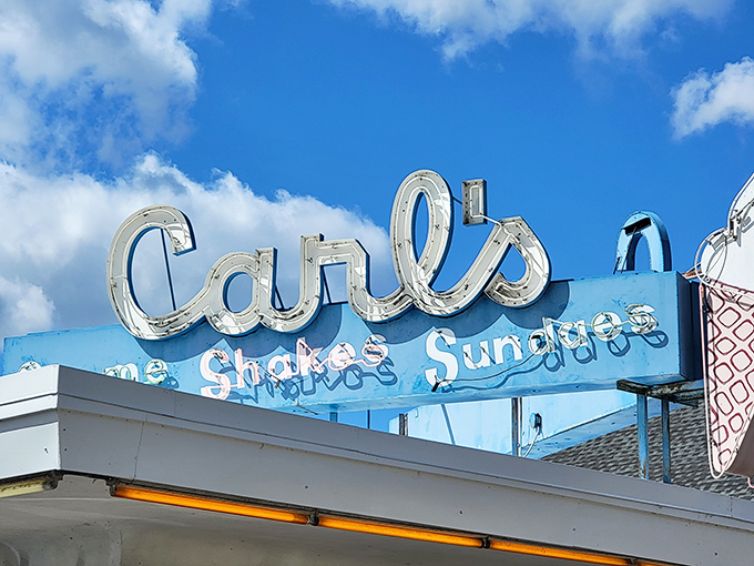 The Carl's sign against blue sky&mdash;a beacon of hope for sweet-toothed travelers. Six letters that spell "happiness" in any language.