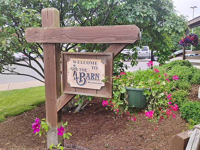 The welcoming sign framed by vibrant flowers sets the tone for your visit. Like a friend's invitation to dinner, only with better cooking.