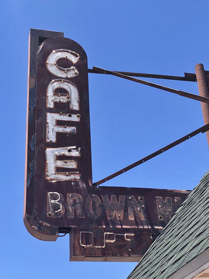 That vintage sign has weathered decades of desert sun, pointing the way to culinary salvation like a neon compass for the hungry and road-weary.