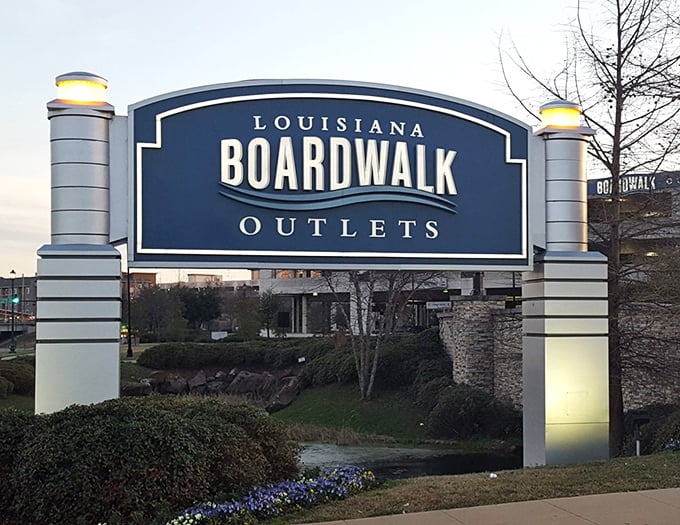 The sign that promises outlet salvation to weary shoppers seeking deals, bargains, and budgets that might actually survive.