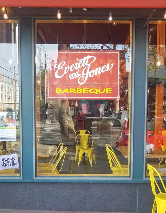 The window sign promises barbecue salvation &ndash; a looking glass into a world where smoke and sauce rule and diet plans go to die happily.