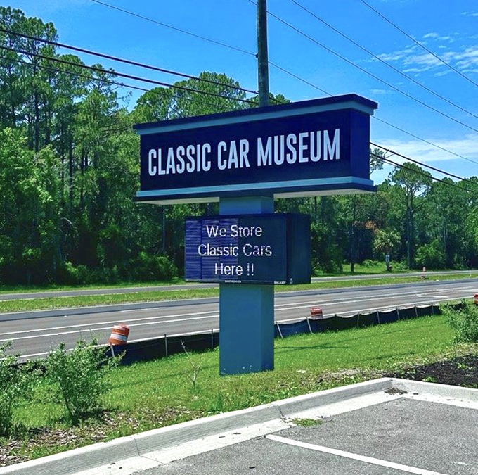 The roadside sign &ndash; automotive poetry in blue and white, calling to passing motorists like a siren song of pistons and chrome.