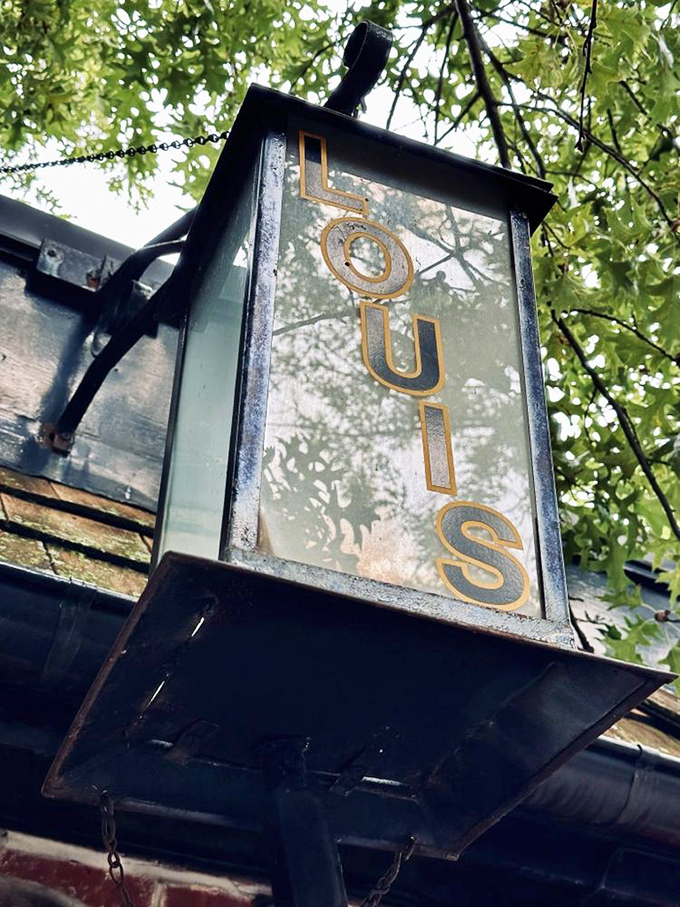 The vintage lantern sign swings gently outside, a beacon guiding burger enthusiasts to what many consider the birthplace of America's favorite sandwich.