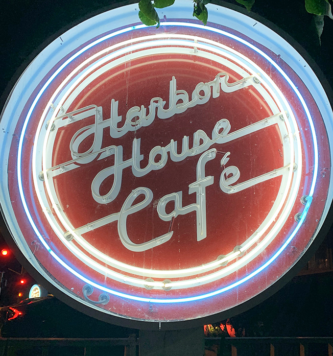That neon sign doesn't just advertise a restaurant&mdash;it's a lighthouse for hungry travelers, glowing with the promise of comfort food at any hour.