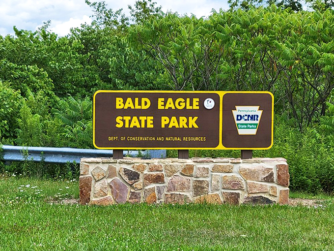 The official welcome sign, standing proud against lush greenery. Not just a marker, but a promise of the natural wonders waiting beyond.
