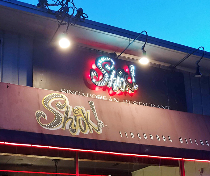 The neon sign glows like a beacon in the night, calling to hungry souls with the promise of "Shiok!"&mdash;that untranslatable feeling of pure satisfaction.