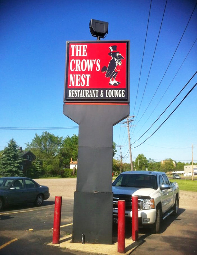 That sign against the blue sky is like a beacon for hungry travelers. The dapper crow in his top hat promises civilized indulgence.