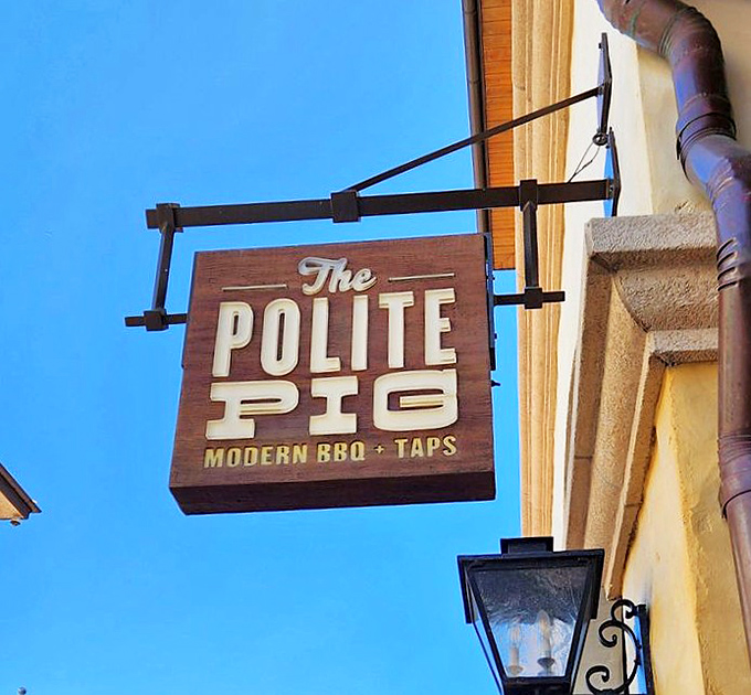 The wooden sign swinging gently in the breeze, like a siren call to those with empty stomachs and a love for all things smoked.