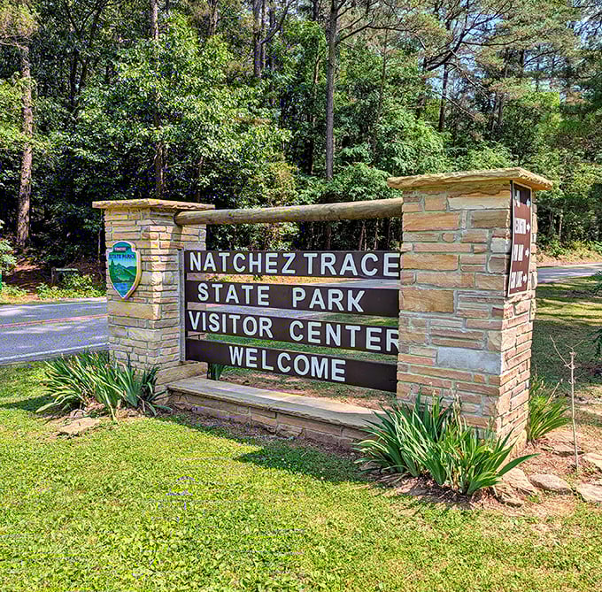 The park entrance sign stands as both welcome and promise: adventures await just beyond these stone pillars.