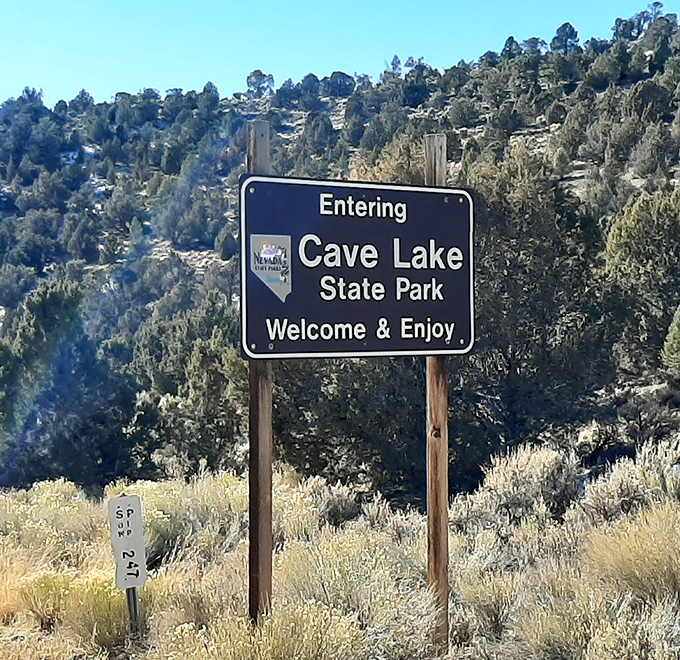 Your official invitation to escape: Cave Lake State Park's welcome sign promises exactly what your stress-addled brain needs.