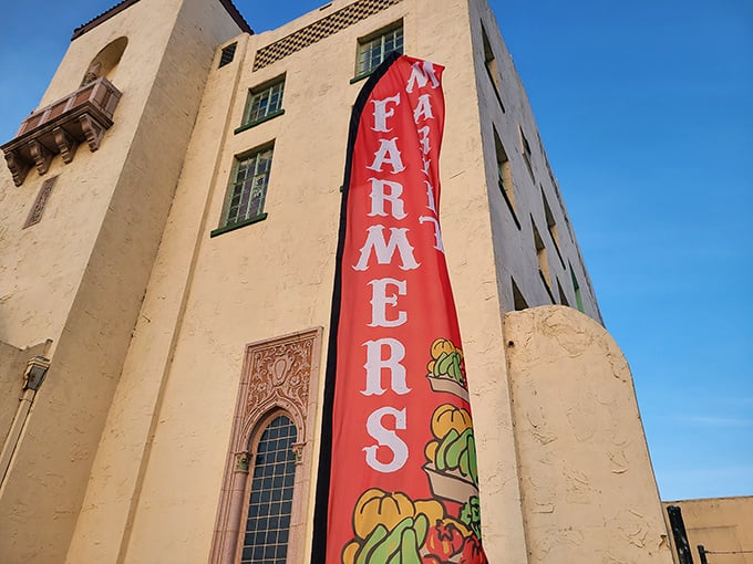 The market's vertical banner announces its presence like a colorful exclamation point against the historic building, a beacon for food lovers across the city.