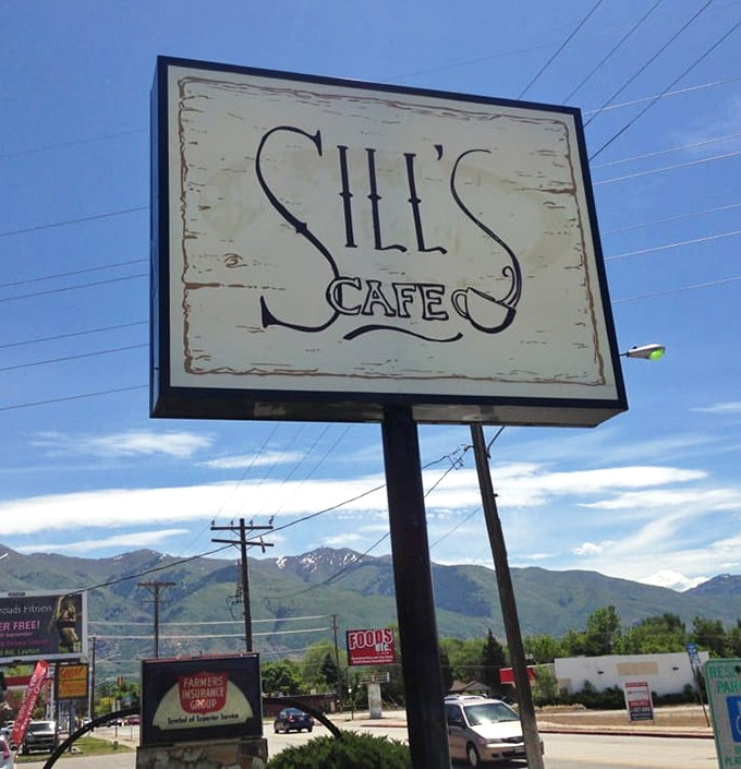 The sign stands as a beacon of hope for the hungry, promising not just a meal but a proper Utah dining institution against a backdrop of mountain majesty.